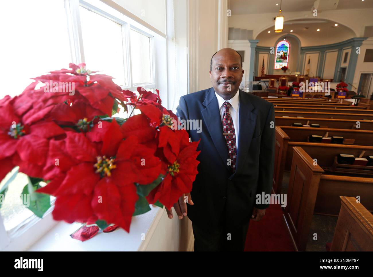 Rev. Reginald Davis poses in the sanctuary of the First Baptist church ...