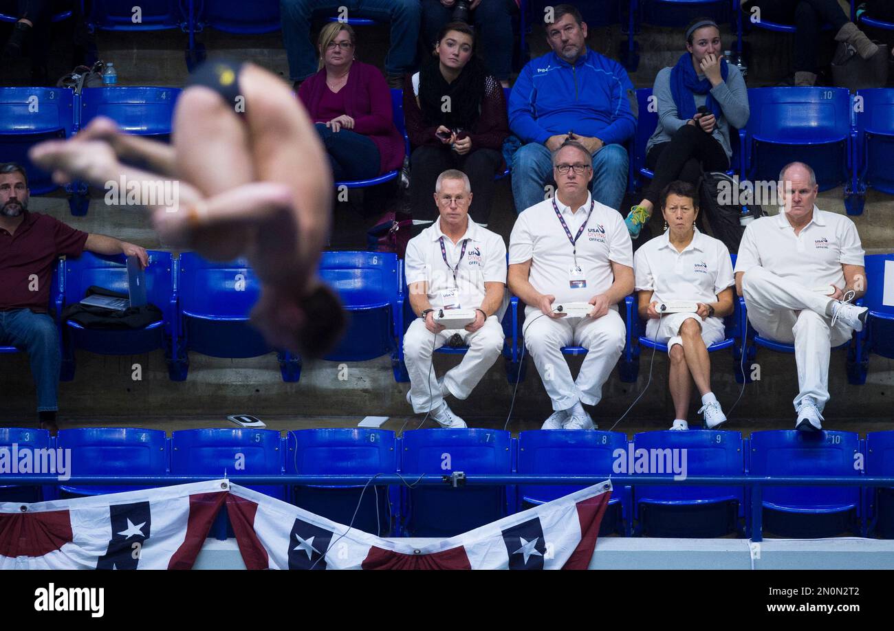 A panel of USA Diving officials watch the performance of a diver during ...