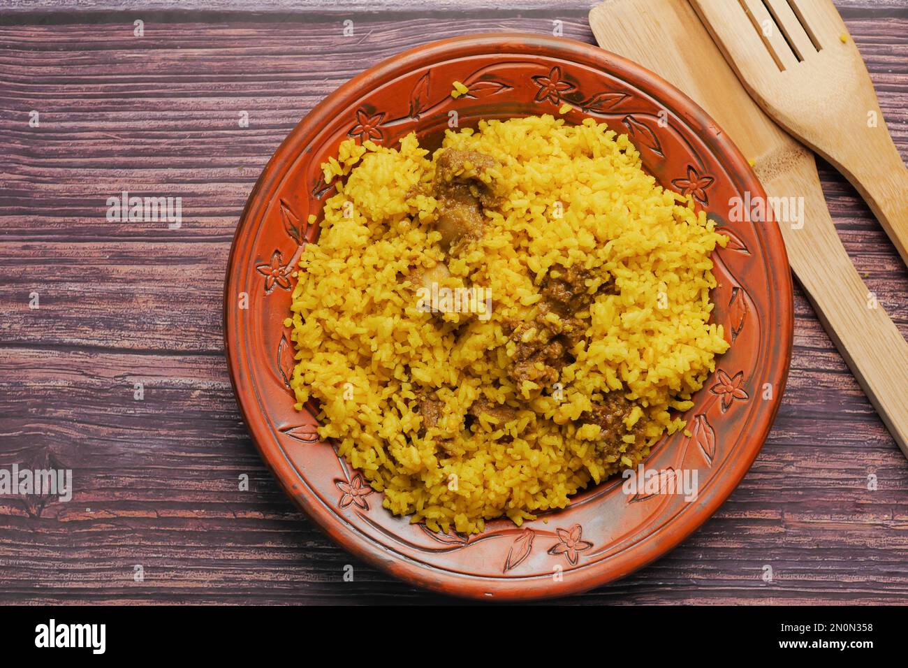 boiled yellow rice with meats on a plate Stock Photo - Alamy