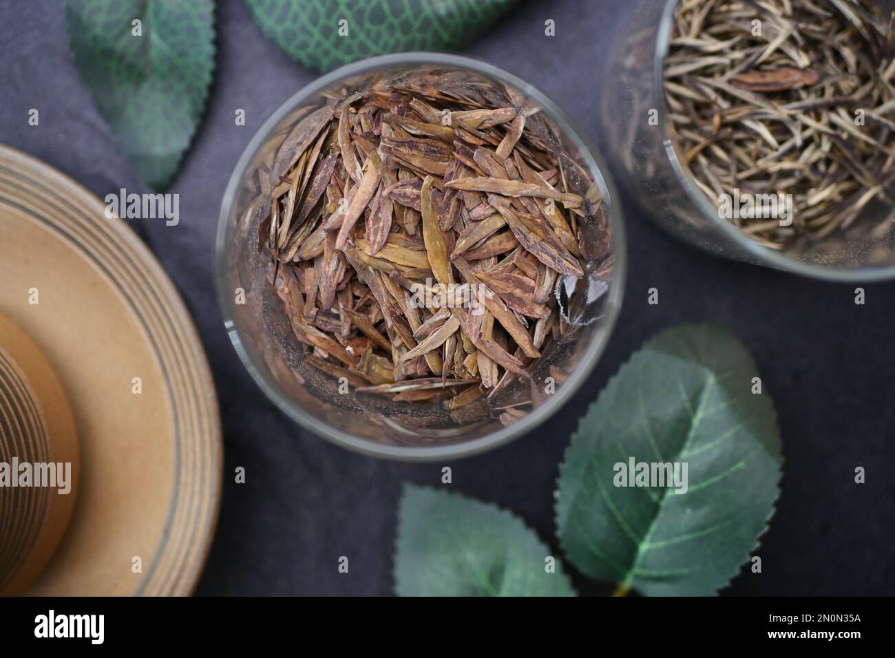 Dry tea leaves in a container on table Stock Photo - Alamy