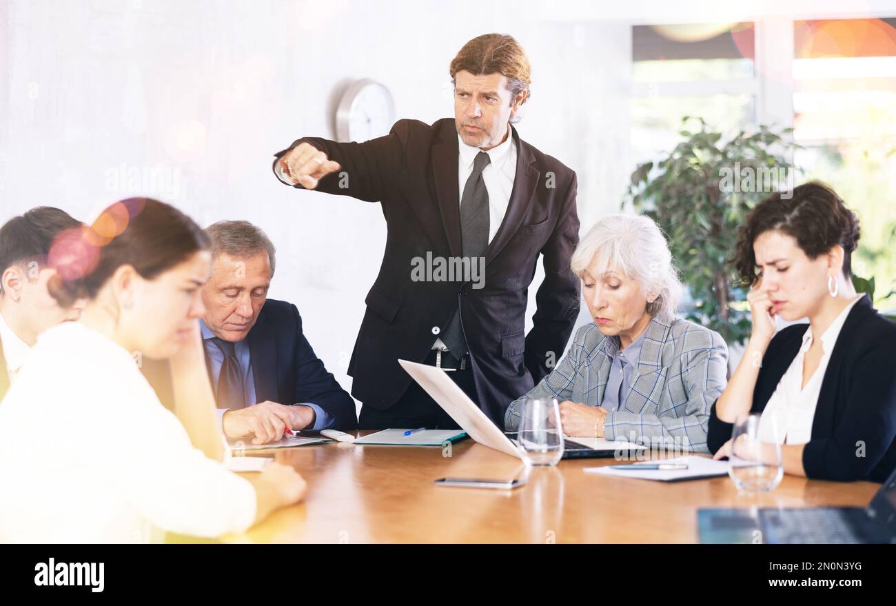 Portrait of angry male boss in business suit pointing to the door to ...
