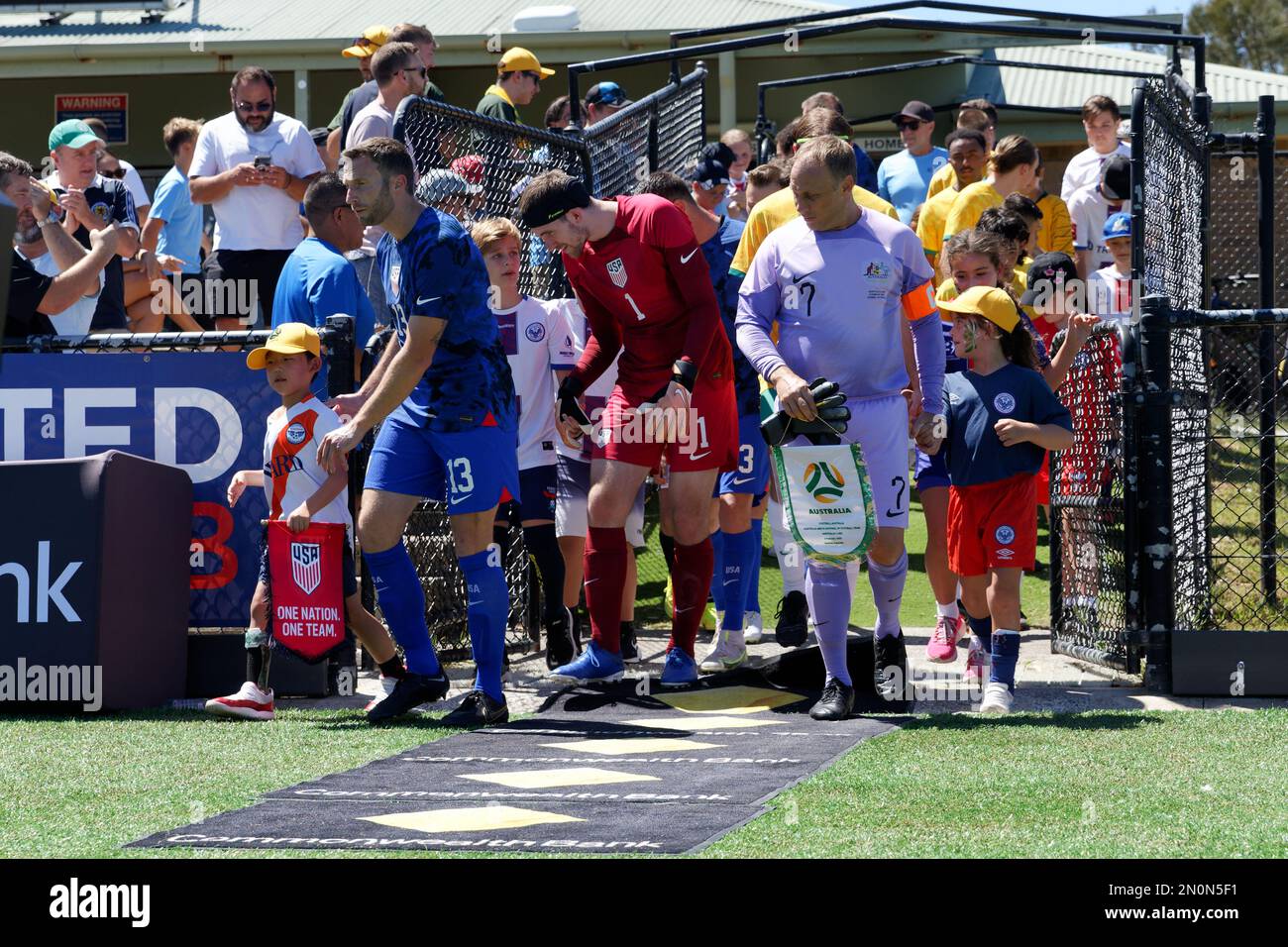 American and Australian players walk onto the pitch before the match ...