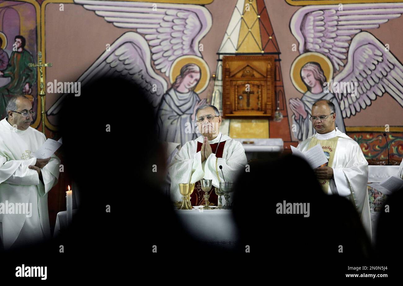 Latin Patriarch of Jerusalem Fouad Twal, center, leads Sunday Mass at ...