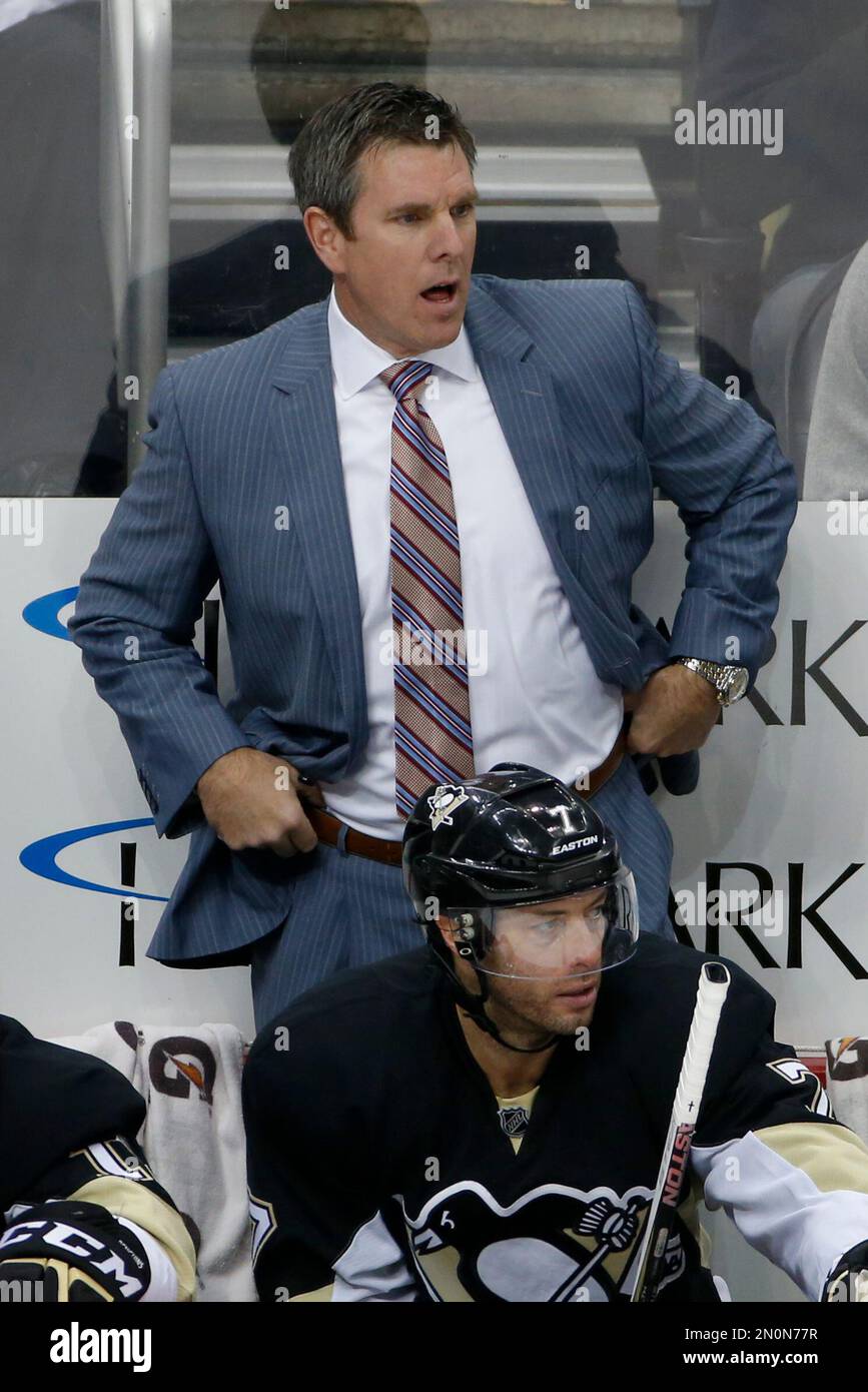 Pittsburgh Penguins coach Mike Sullivan stands behind his bench during ...