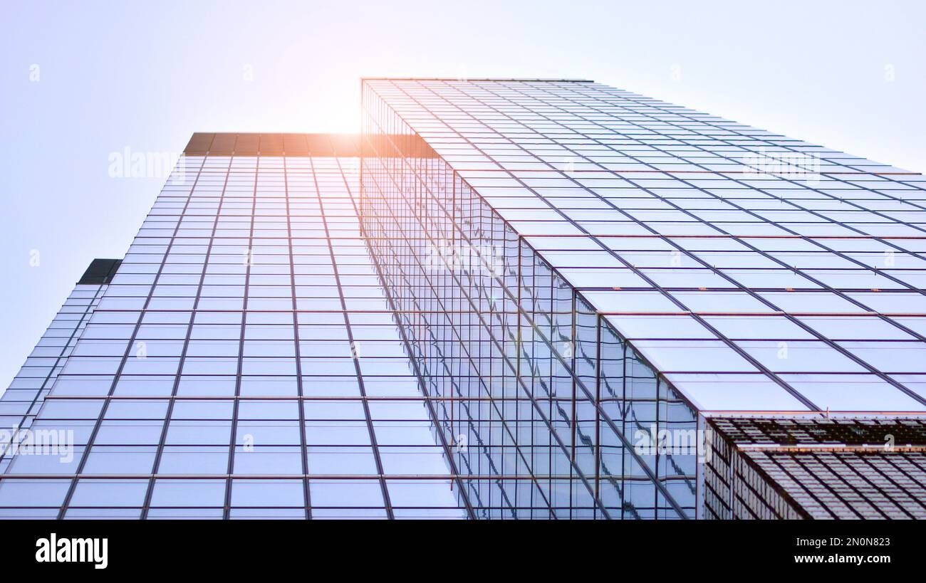 Bottom view of modern skyscrapers in business district against blue sky ...