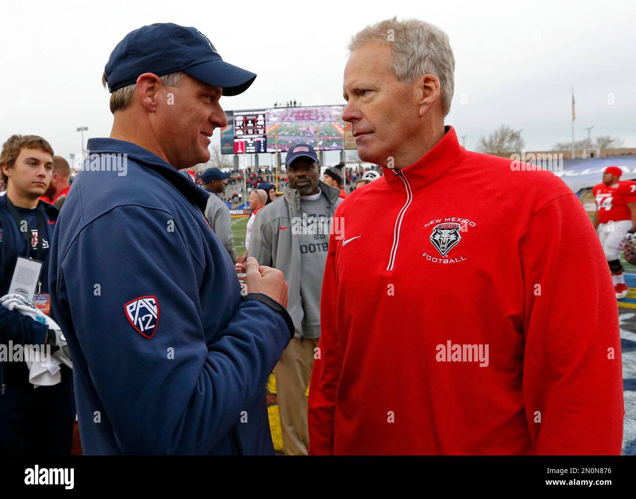 Arizona head coach Rich Rodriguez, left, talks with New Mexico head ...