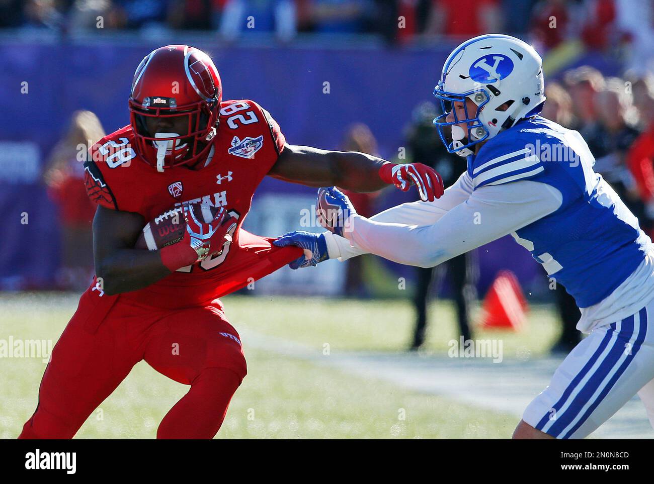 Utah running back Joe Williams (28) breaks a tackle by BYU defensive ...