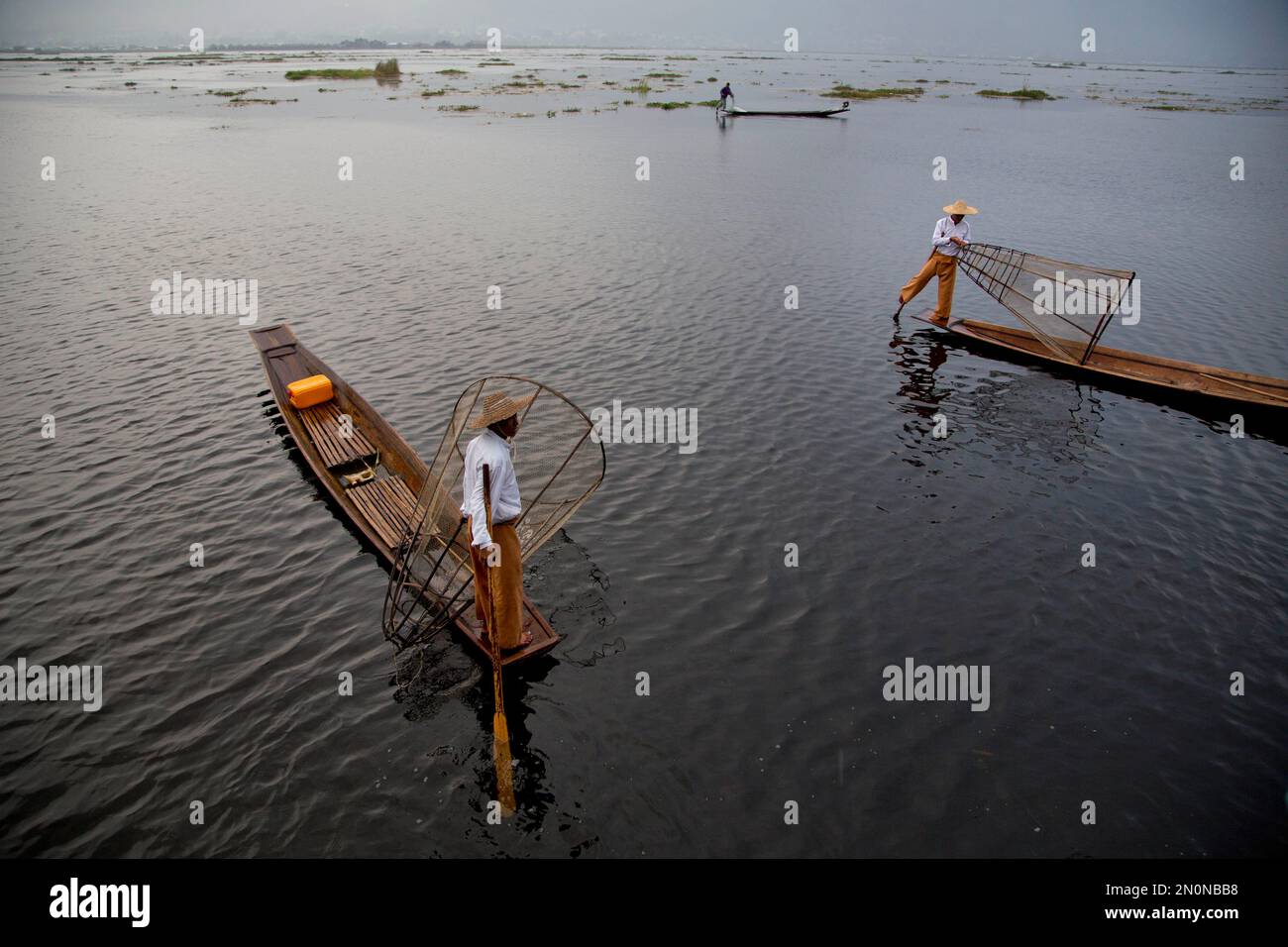 Ethnic Intha fishermen dressed in customary attire with traditional ...