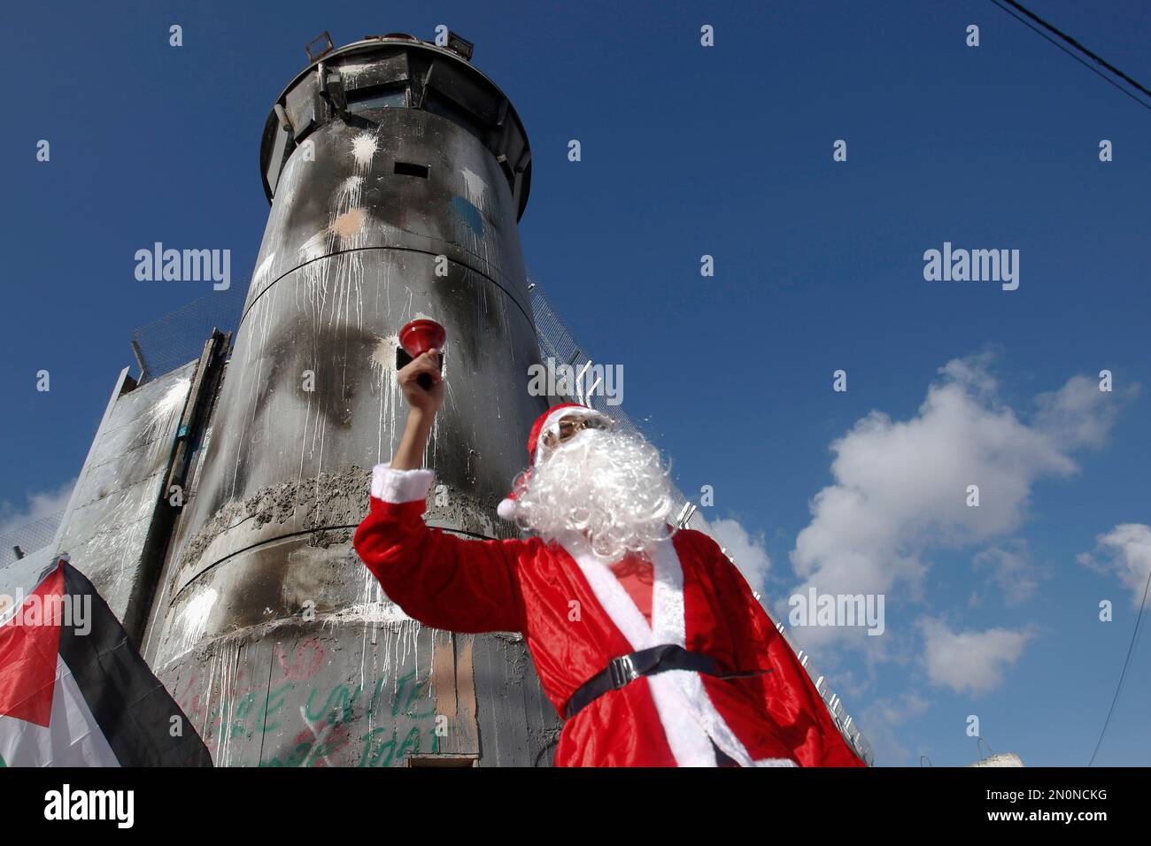 A Palestinian demonstrator dressed as Santa Claus stands in front of an ...