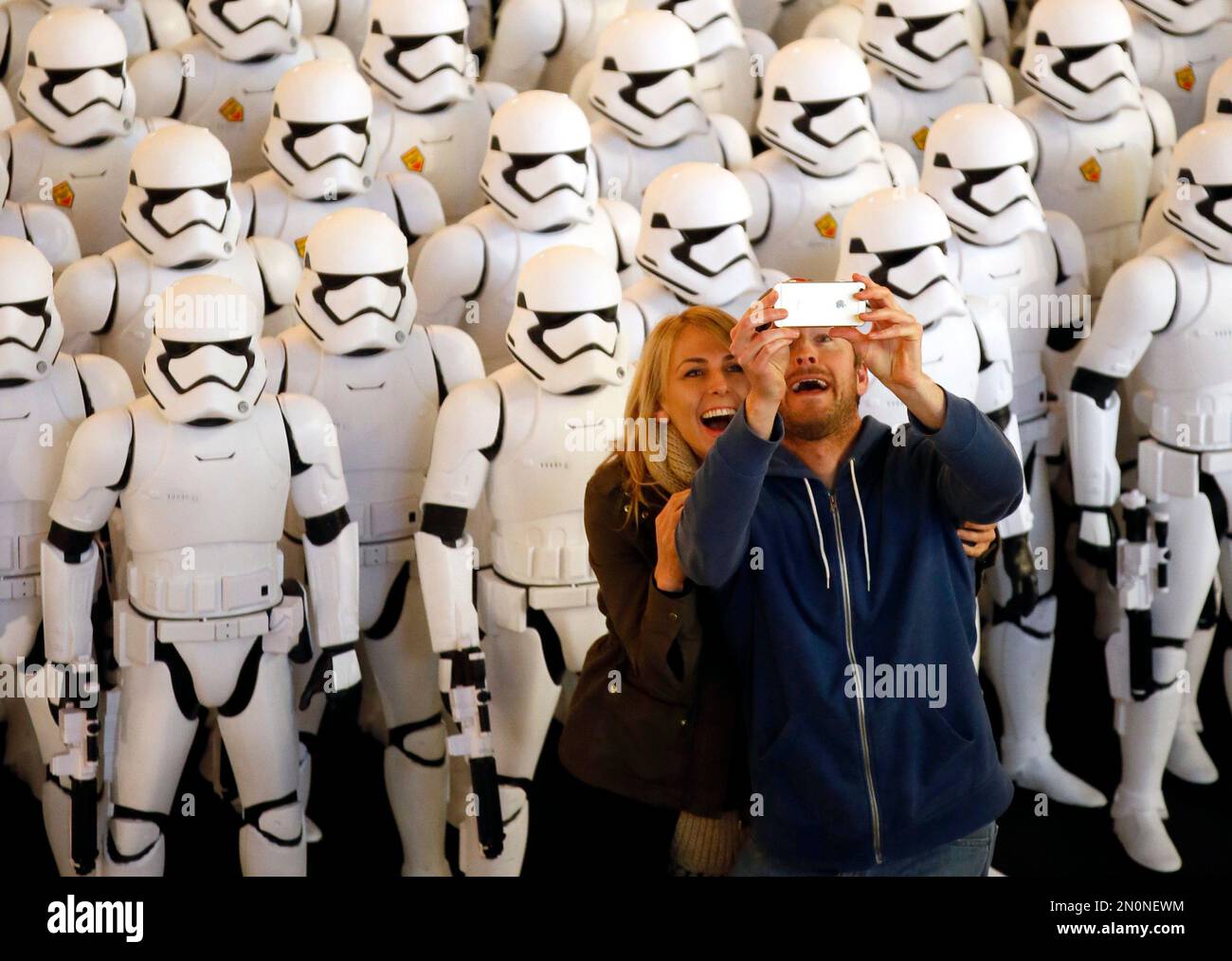 A couple takes a selfie together in front of over 100 JAKKS BIG-FIGS ...