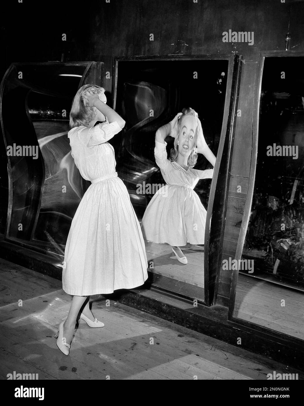 Ingrid Goude, Miss Sweden entrant in the Miss Universe Pageant, puts ...