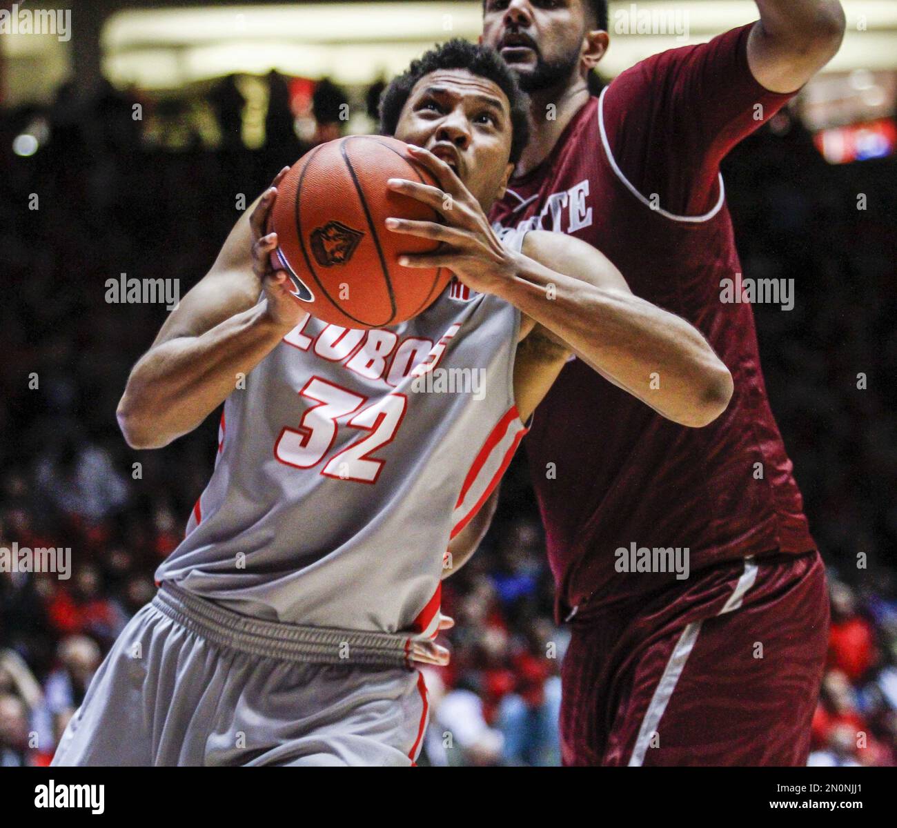 New Mexico's Tim Williams (32) drives to the basket as New Mexico State ...