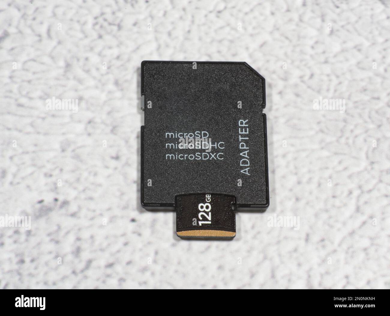 Top view of microSD memory card partially inserted into SD adapter ...