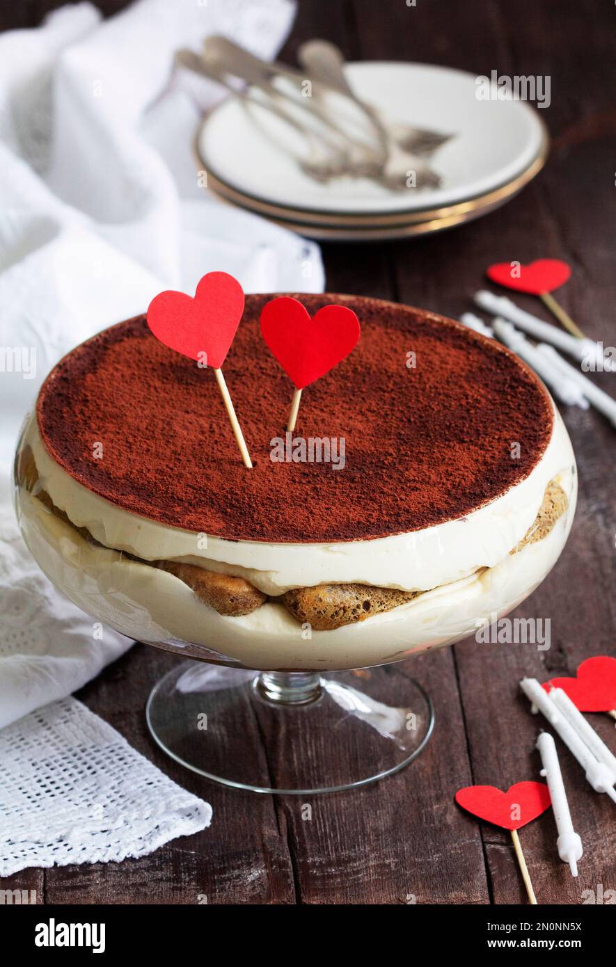 Traditional Italian dessert tiramisu served in a glass vase decorated ...