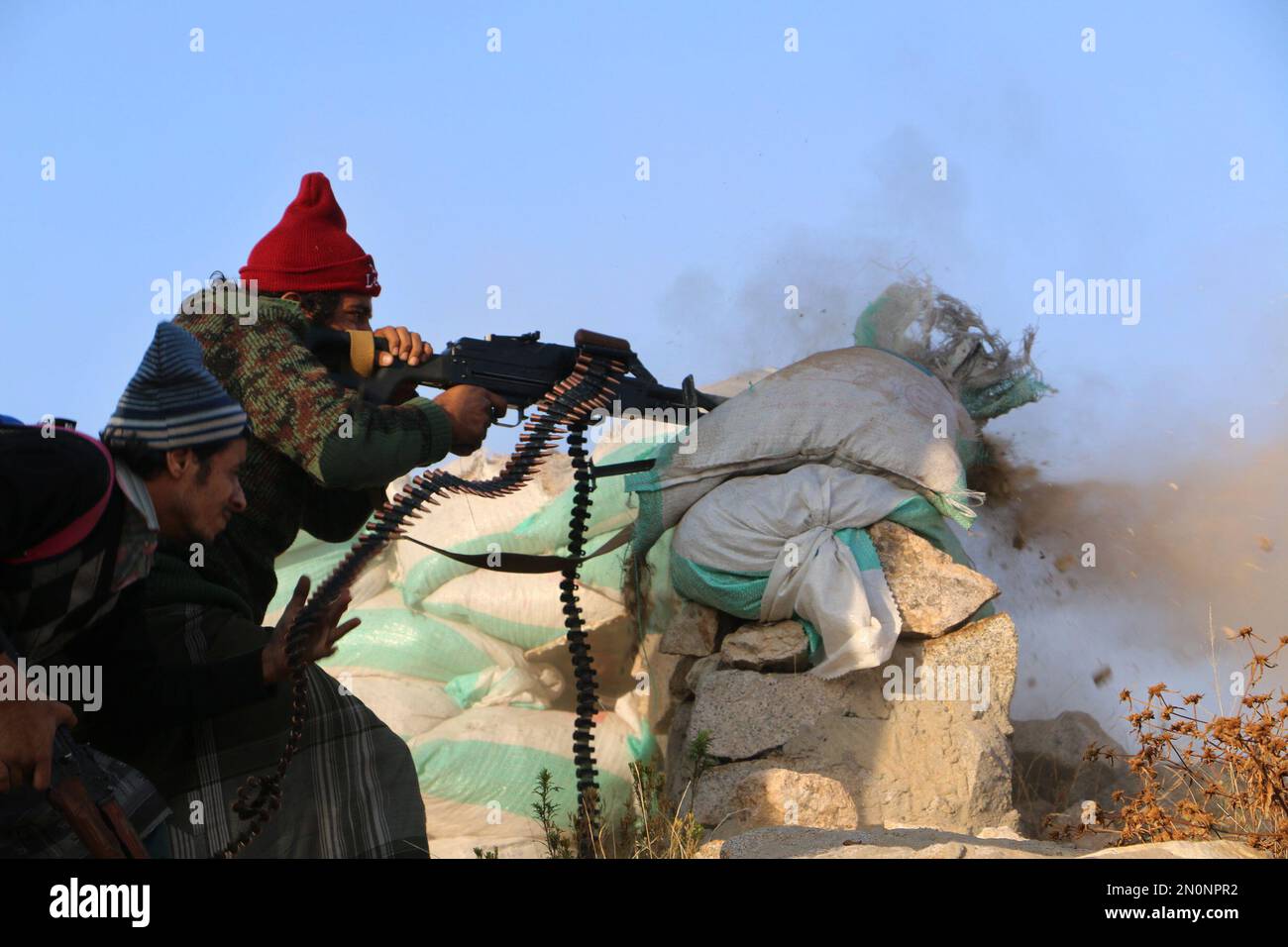 Tribal fighters take position on a street during fighting with Shiite ...