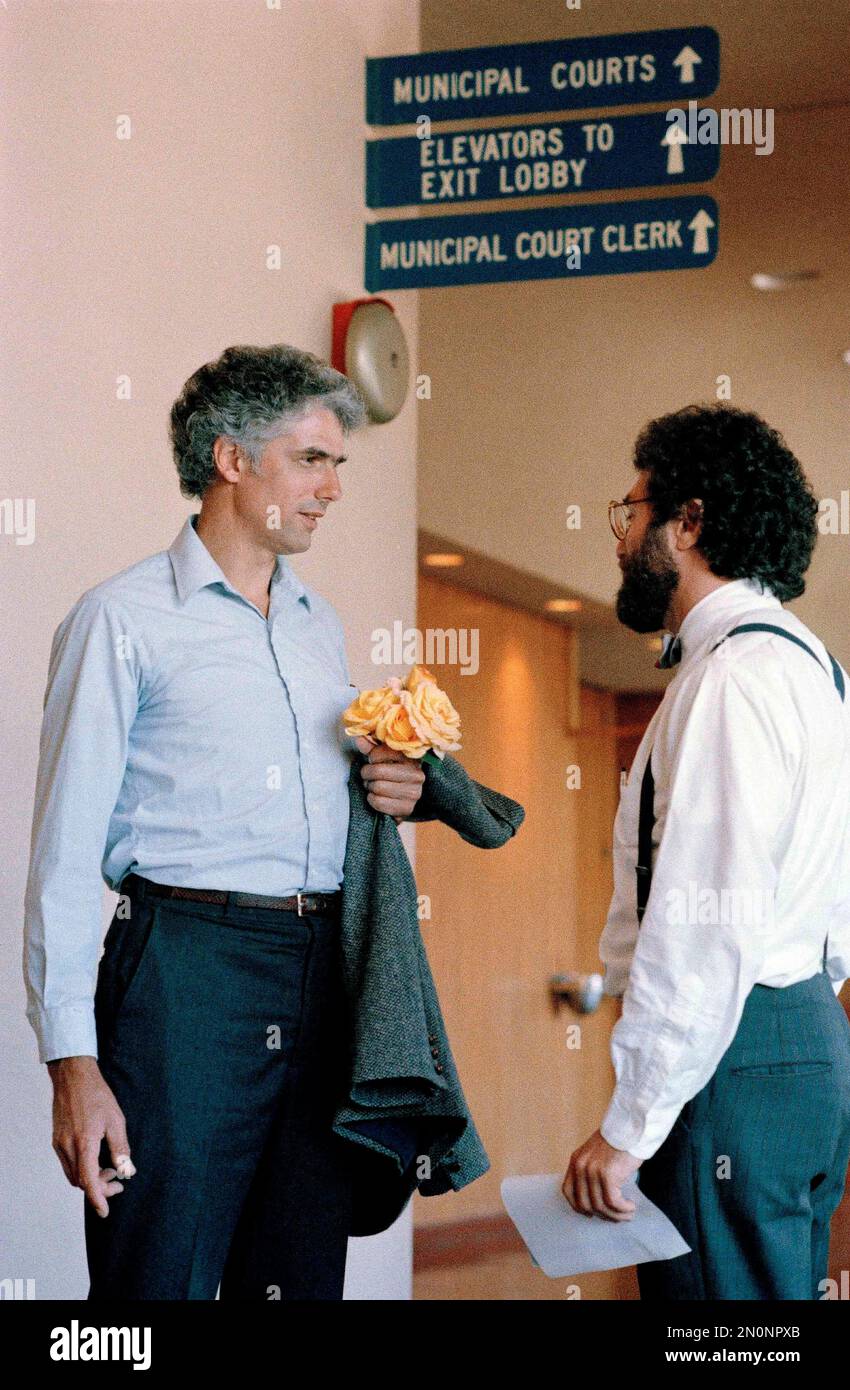 Holding a bouquet presented to him by a well-wisher, former fugitive ...