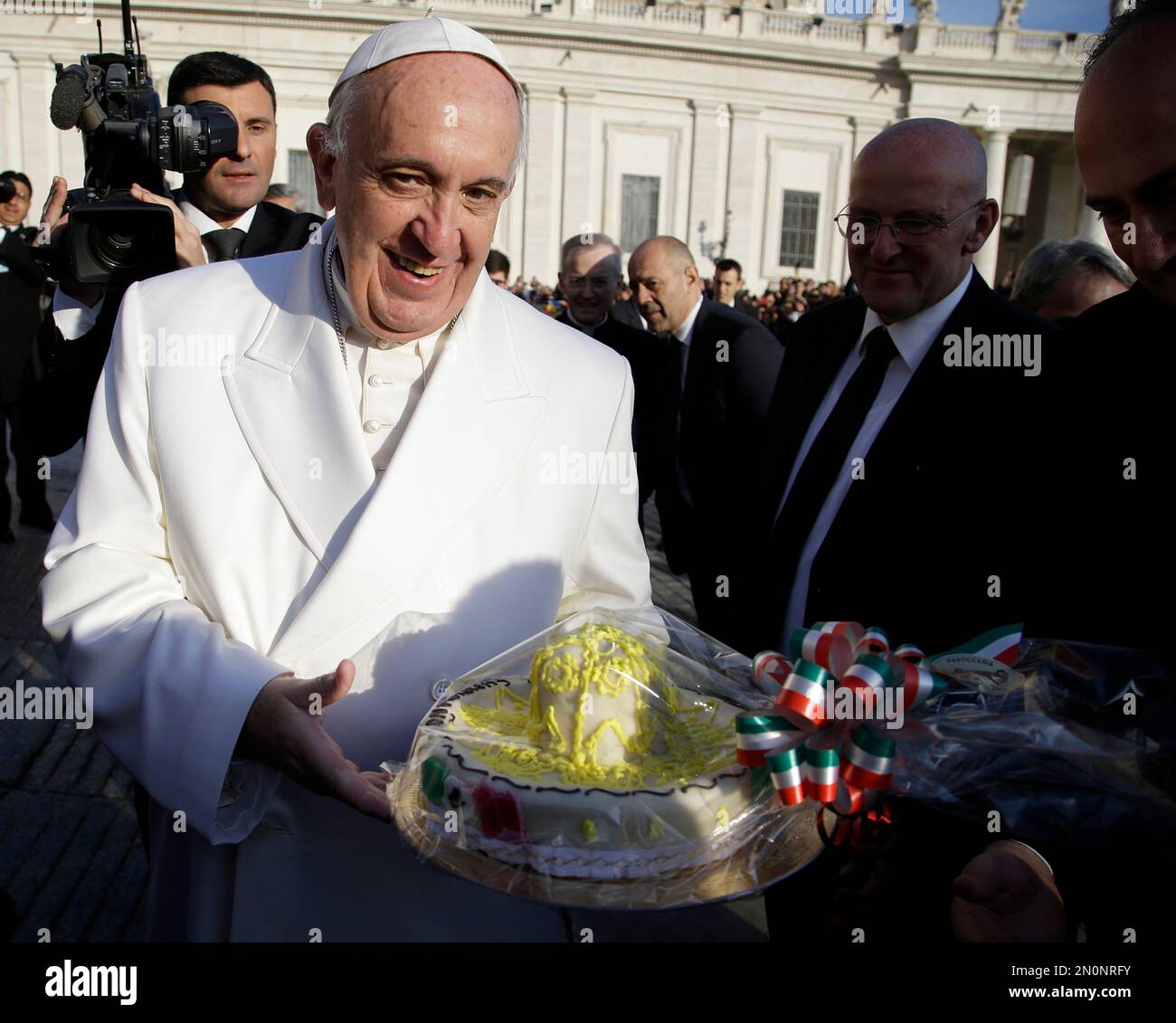 Pope Francis holds a birthday cake shaped as a Mexican sombrero which ...