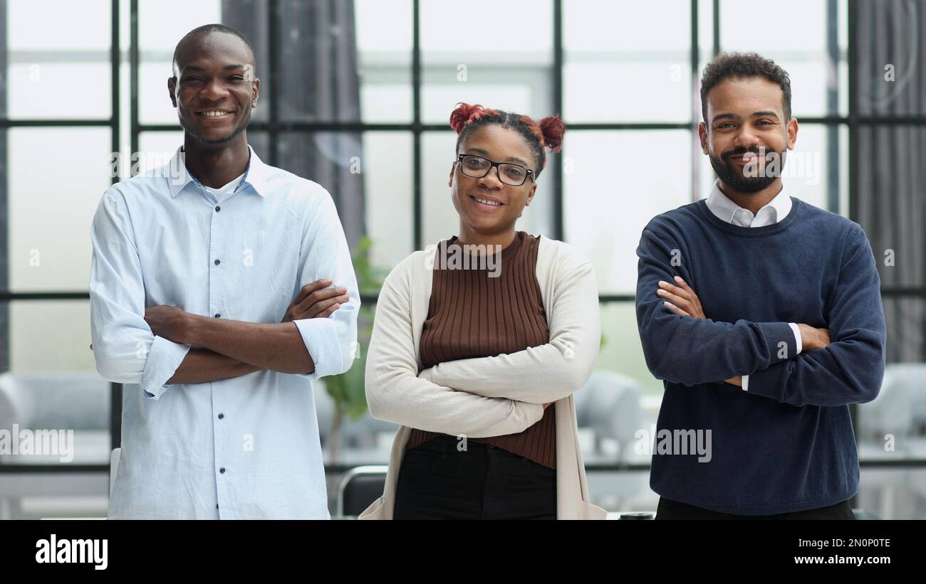 Business team in an office smiling at the camera Stock Photo - Alamy