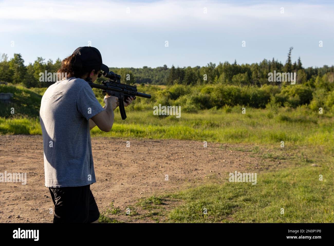 man target shooting with black stock rifle Stock Photo - Alamy