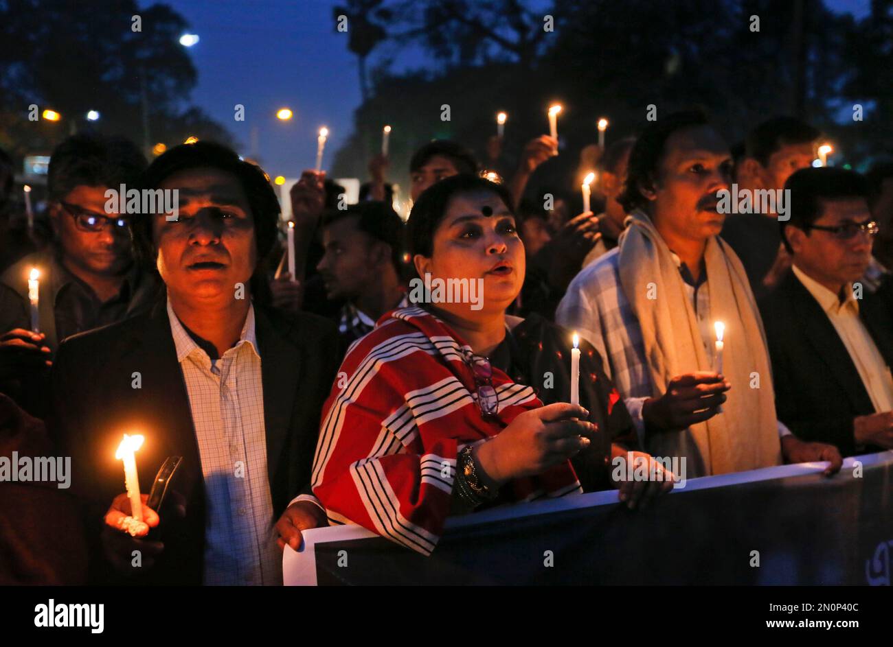 Bangladeshi people hold lighted candles and walk in a rally during Martyrs Day in Dhaka ...