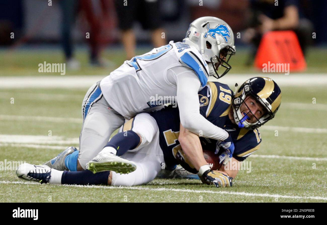 St. Louis Rams wide receiver Wes Welker, bottom, is stopped by Detroit ...