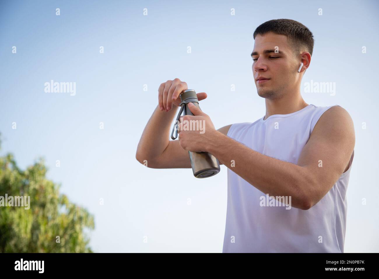 An athlete drinks water during training, concept of hydration during ...