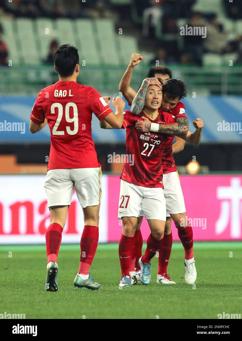 Team mates congratulate Gangzhou Evergrande FC’s Zheng Long, center ...