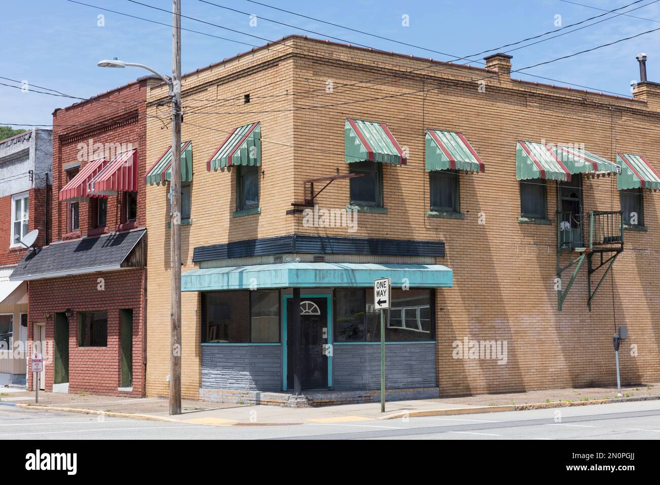 Apartment buildings and storefronts along an empty street Stock Photo ...