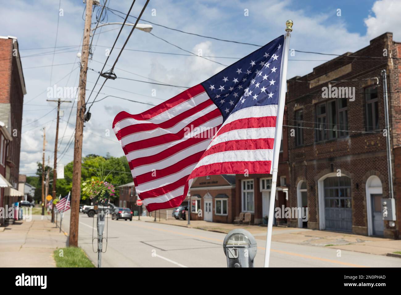 American flag fluttering in the breeze on a deserted main street Stock ...