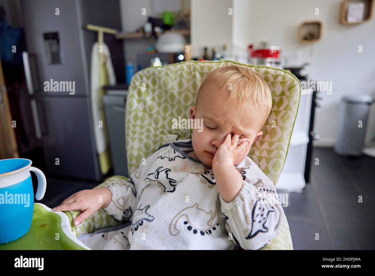 Toddler reaching up and touching appliance in kitchen Stock Photo - Alamy