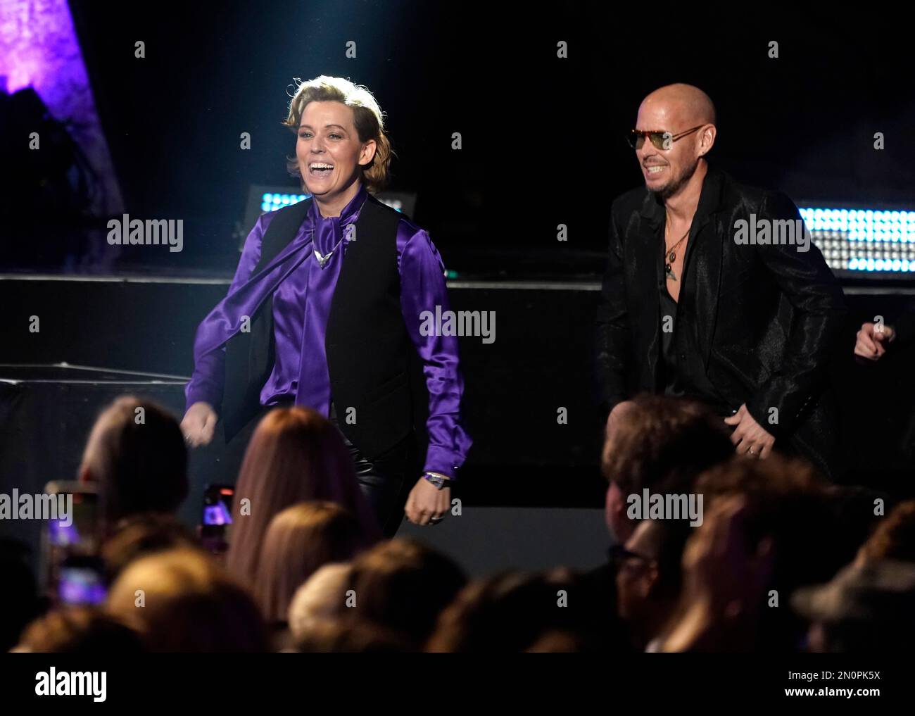 Brandi Carlile, from left, and Phil Hanseroth walk onstage to accept ...
