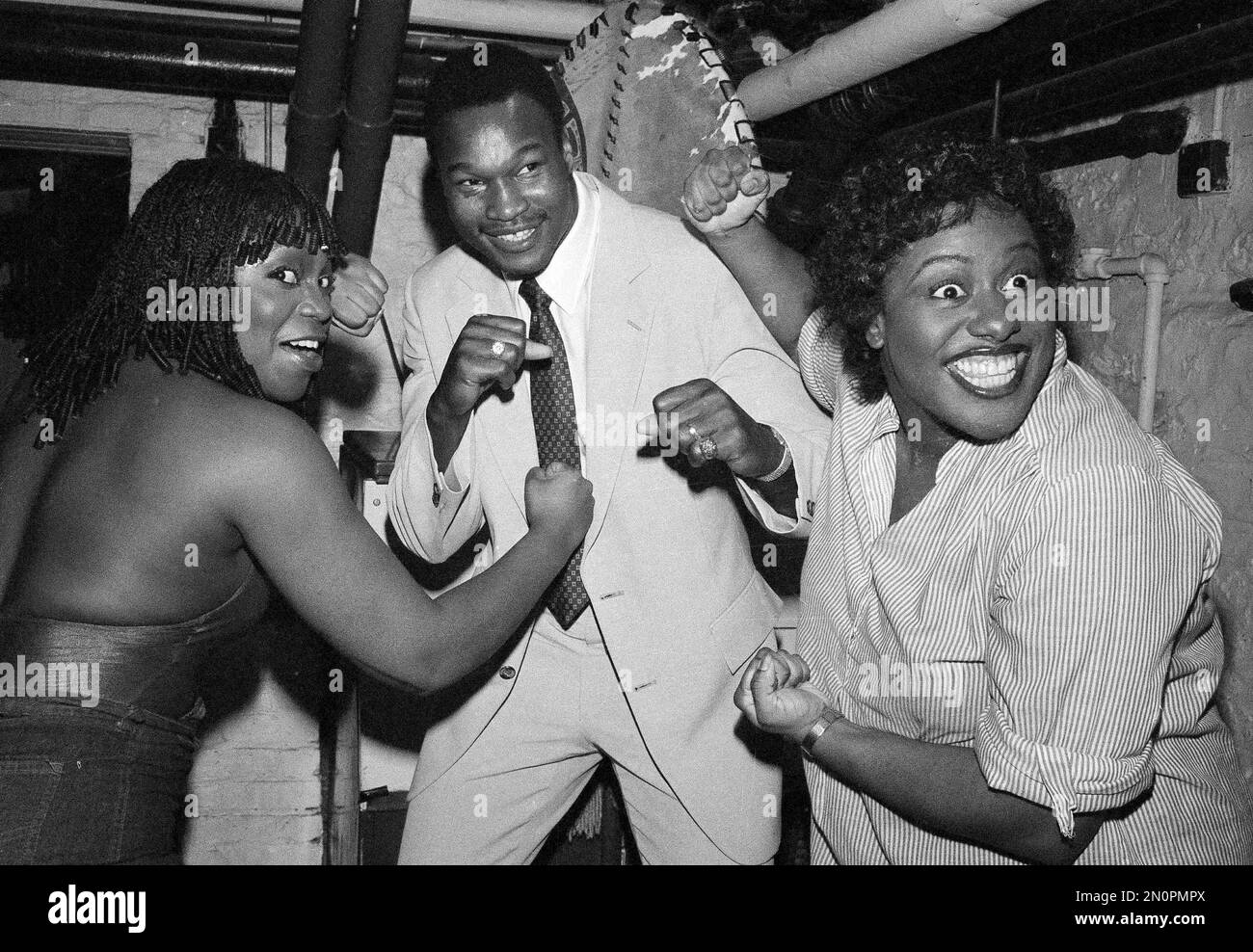 Boxer Larry Holmes, center, Sheila Ellis, left, and Jennifer Yvette ...