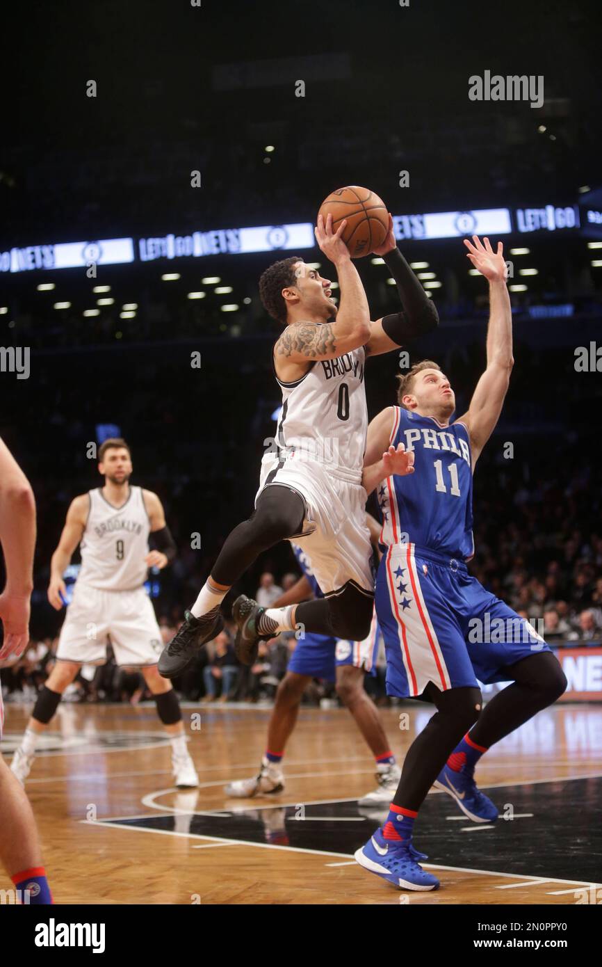 Brooklyn Nets' Shane Larkin (0) shoots over Philadelphia 76ers' Nik ...