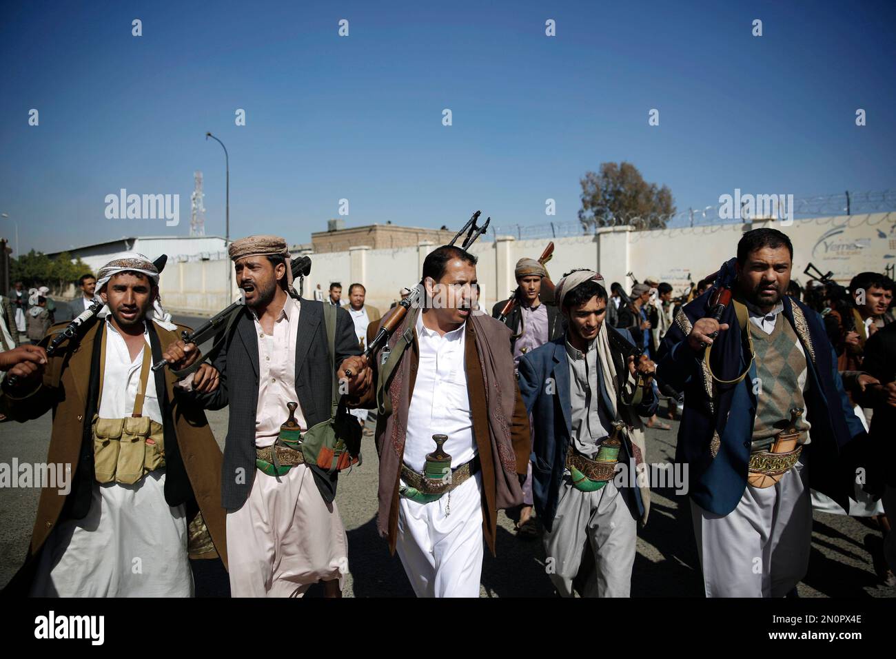 Shiite fighters, known as Houthis, chant slogans during a tribal ...