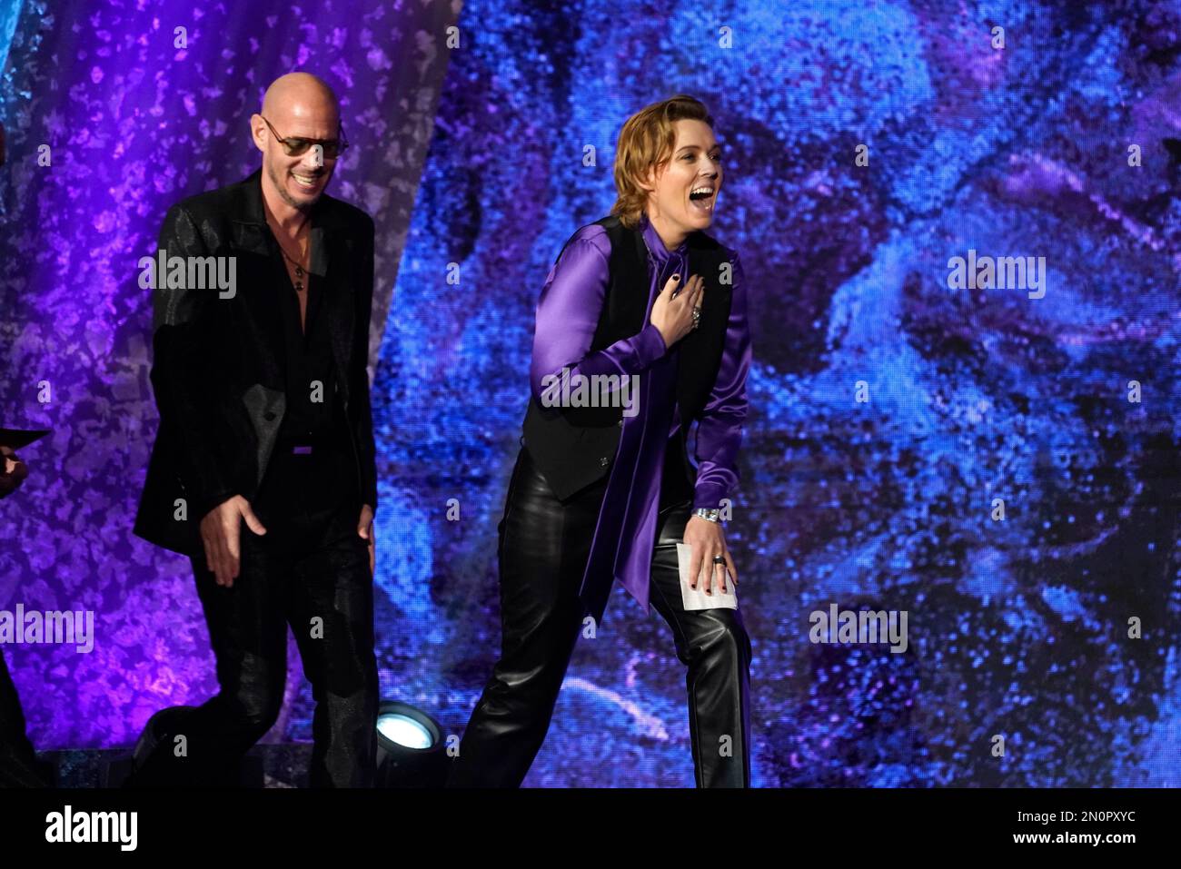 Phil Hanseroth, left, and Brandi Carlile walk on stage to accept the ...