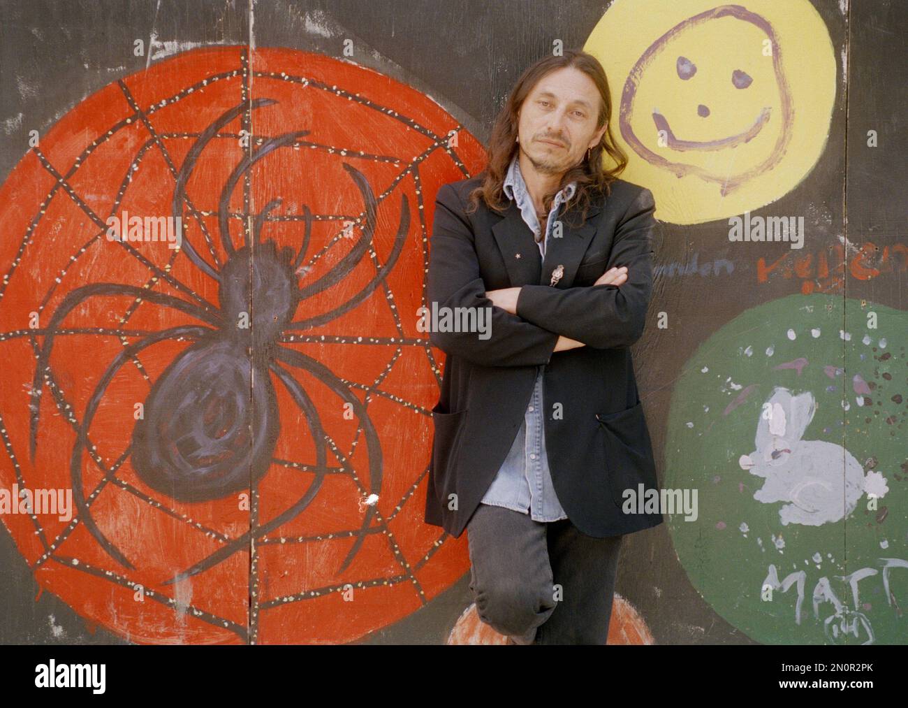 Poet and Native American activist John Trudell poses against a mural in ...