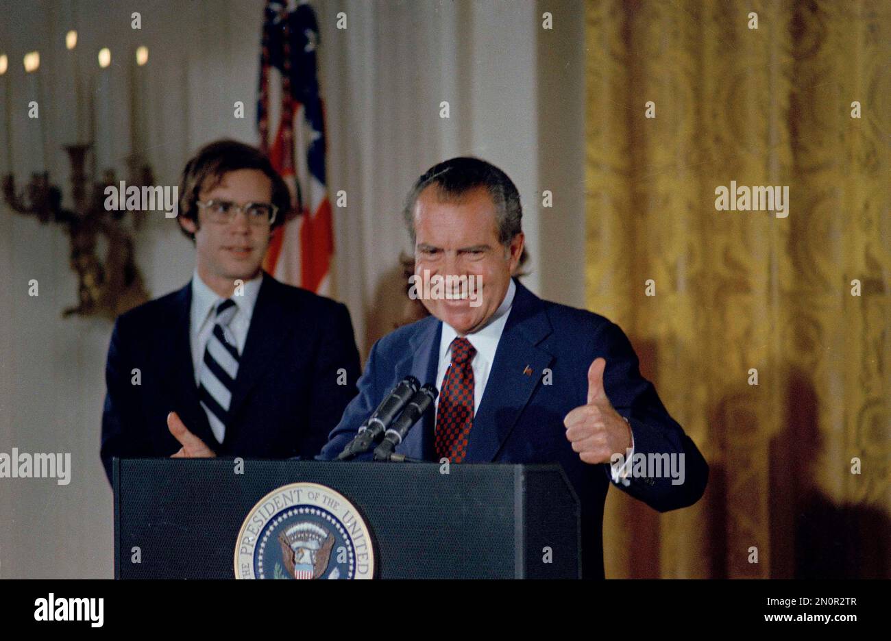 President Richard M. Nixon smiles and gives a thumbs up during an ...