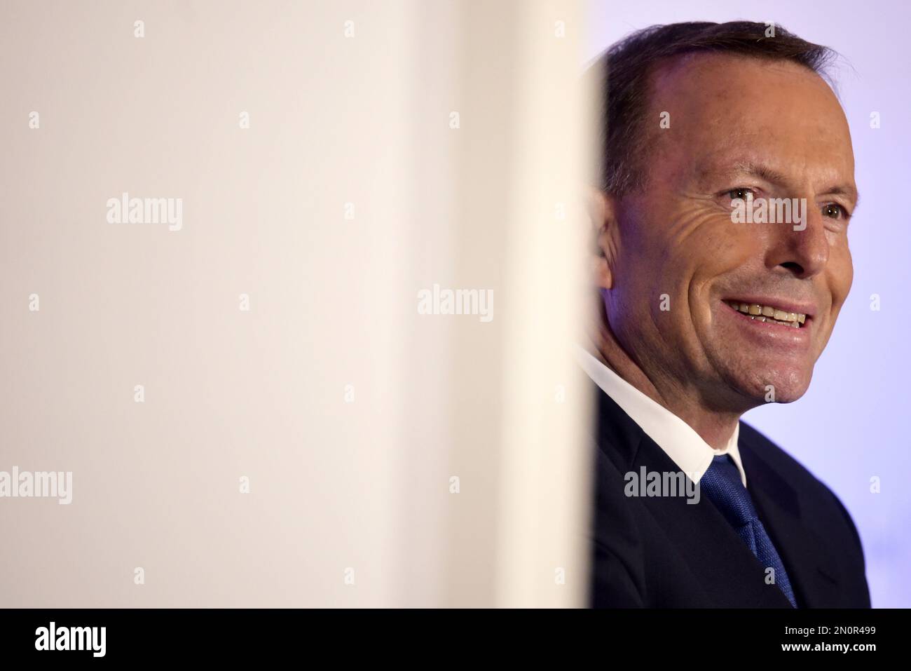 Former Australian Prime Minister Tony Abbott listens to himself being ...