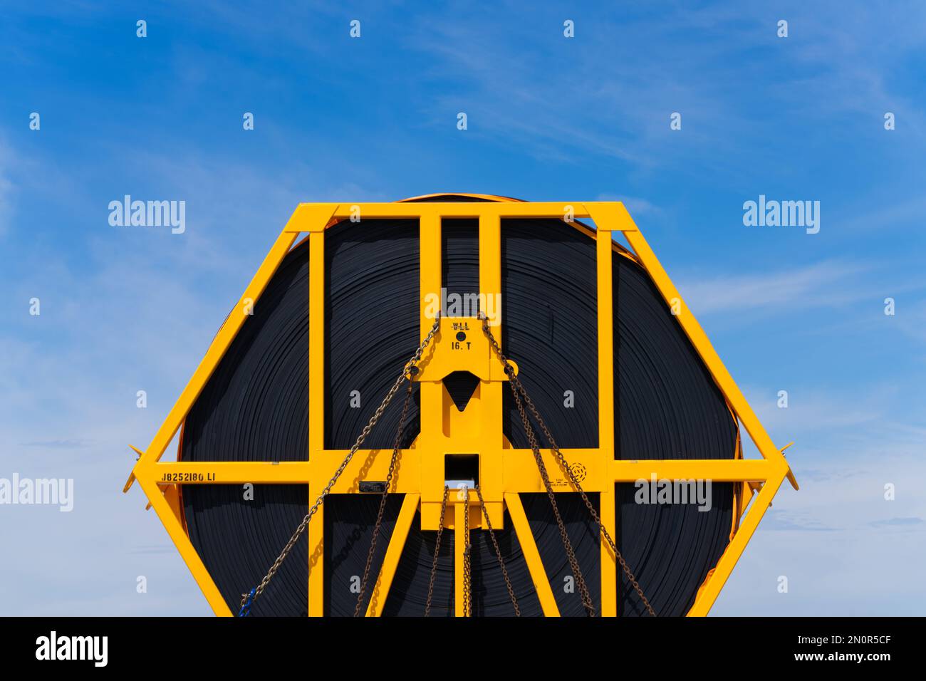 Steel coil shipment in a yellow container with support chains attached ... Steel coil shipment in a yellow container with support chains attached ...