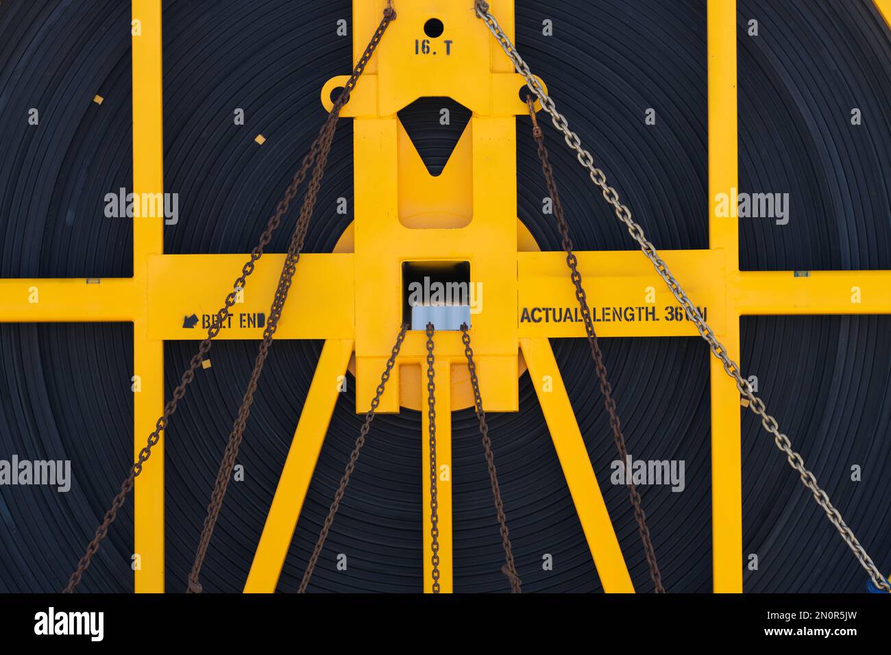 Steel coil shipment in a yellow container with support chains attached ...