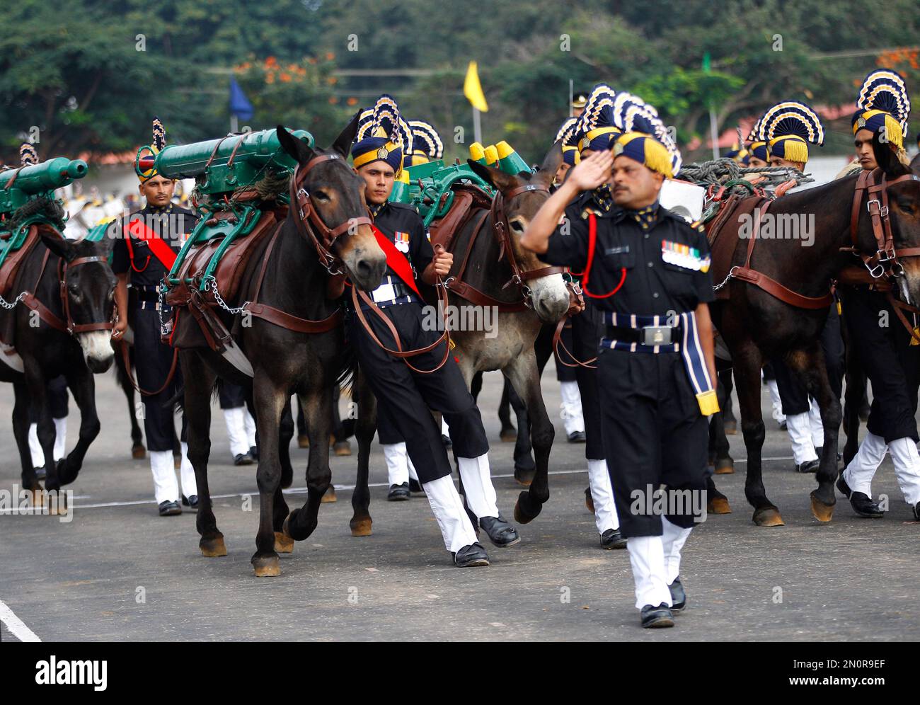 An Indian army soldier struggles to control the mule as they ...