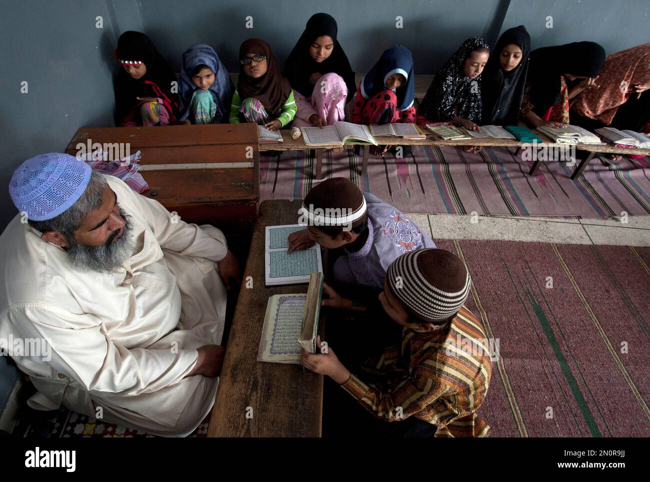 Pakistani Muslim children attend lessons at an Islamic seminary to ...