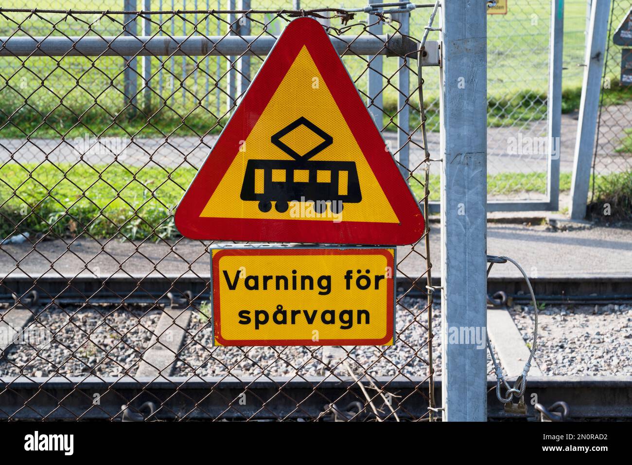 Passage over Tram Tracks with a Warning sign in Swedish Stock Photo - Alamy