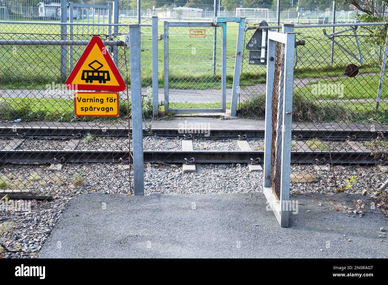 Passage over Tram Tracks with a Warning sign in Swedish Stock Photo - Alamy
