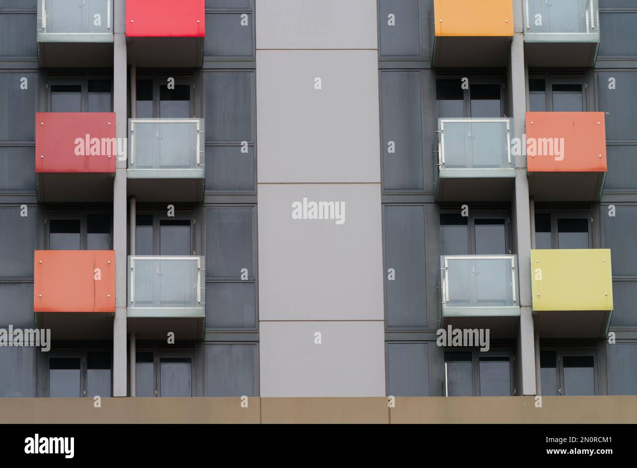 Apartment building exterior view with multi colour balconies and a ...