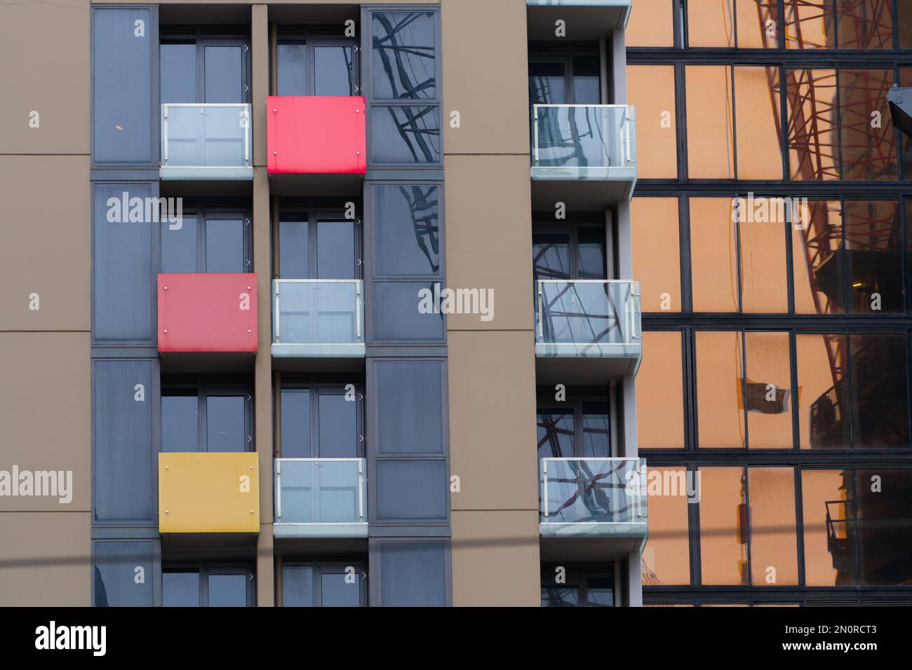 Apartment building exterior view with multi colour balconies and a ...
