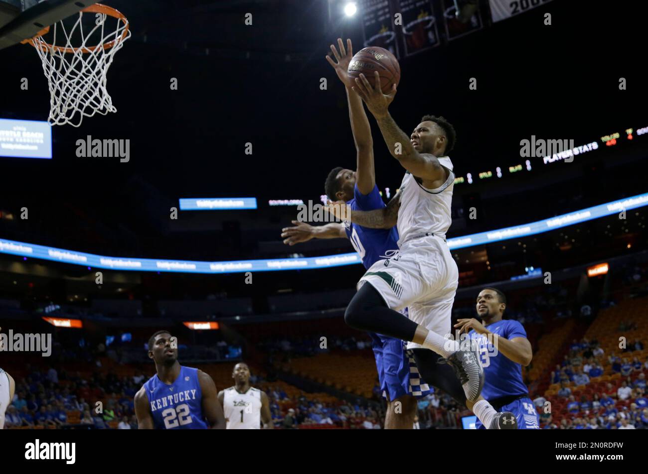 South Florida guard Roddy Peters, right, shoots as Kentucky forward ...