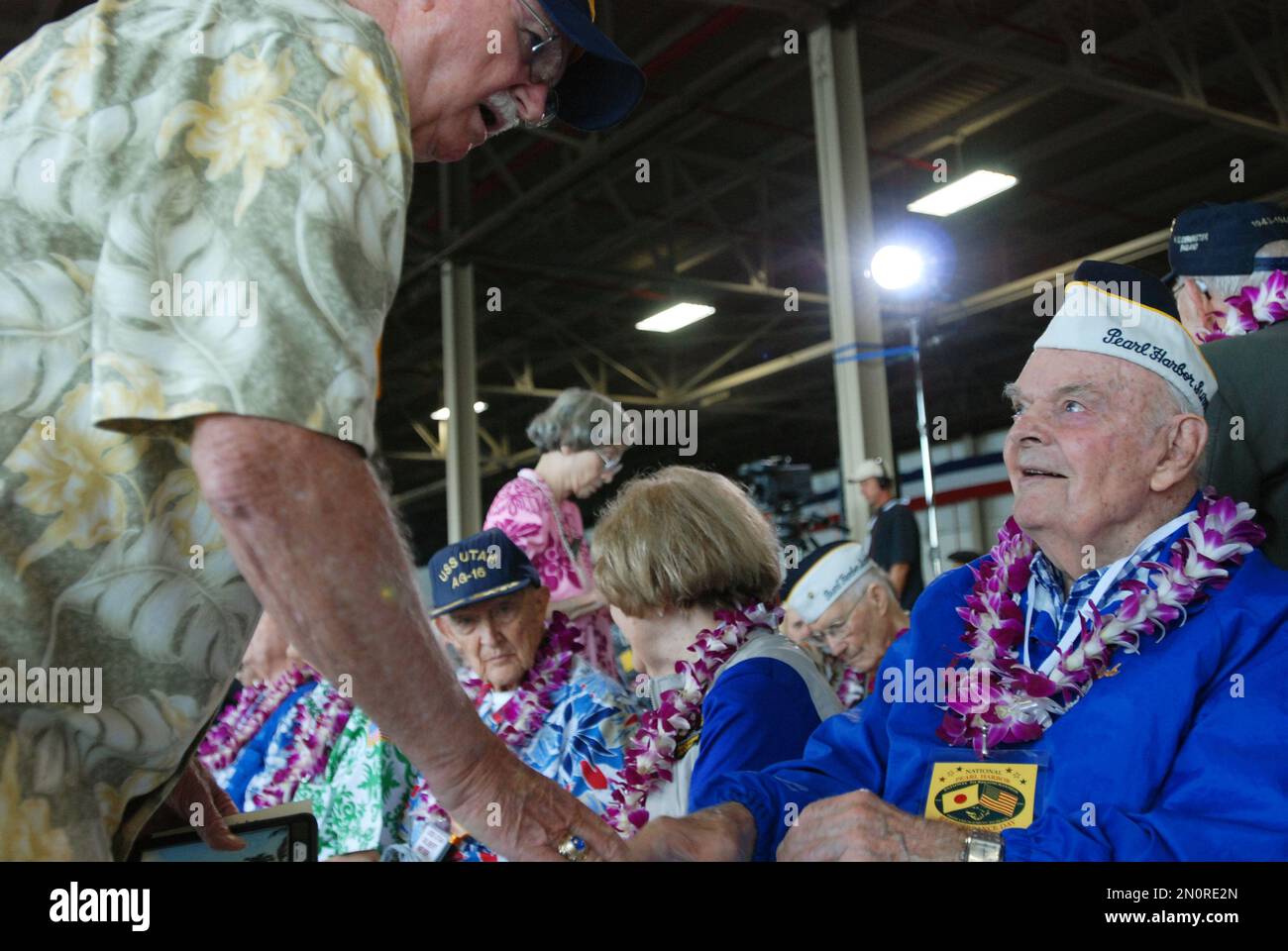 Pearl Harbor survivor Robert Irwin shakes the hand of his brother ...