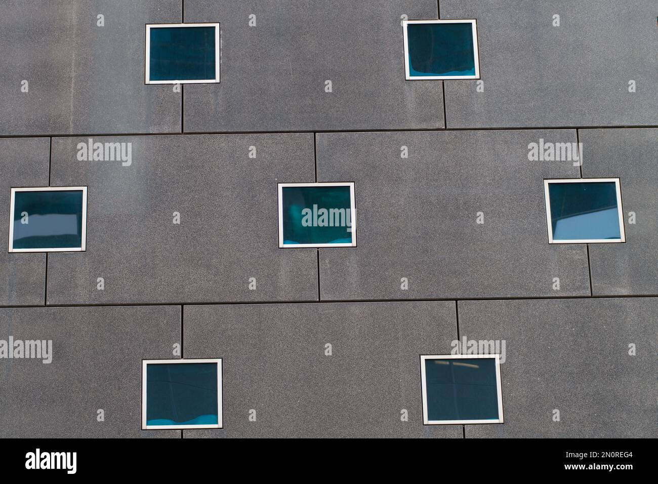 Small apartment building exterior view with geometric square glass ...