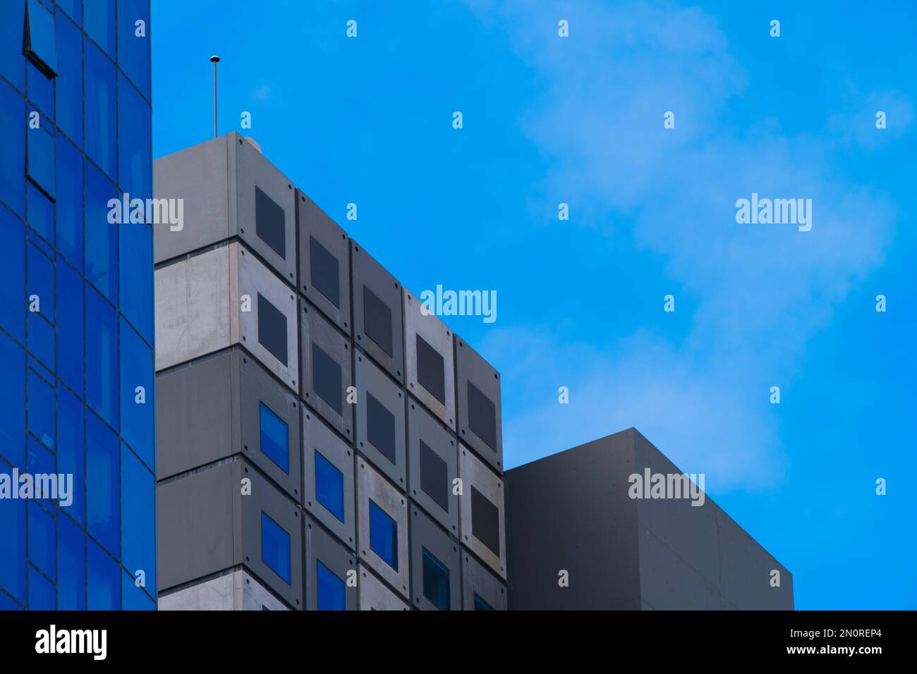 Abstract apartment blocks in concrete structures with a blue sky ...